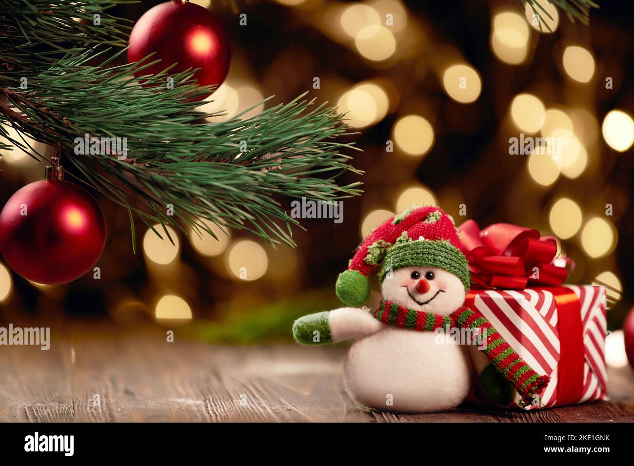 cheerful snowman and boxes with Christmas presents on a festive ...