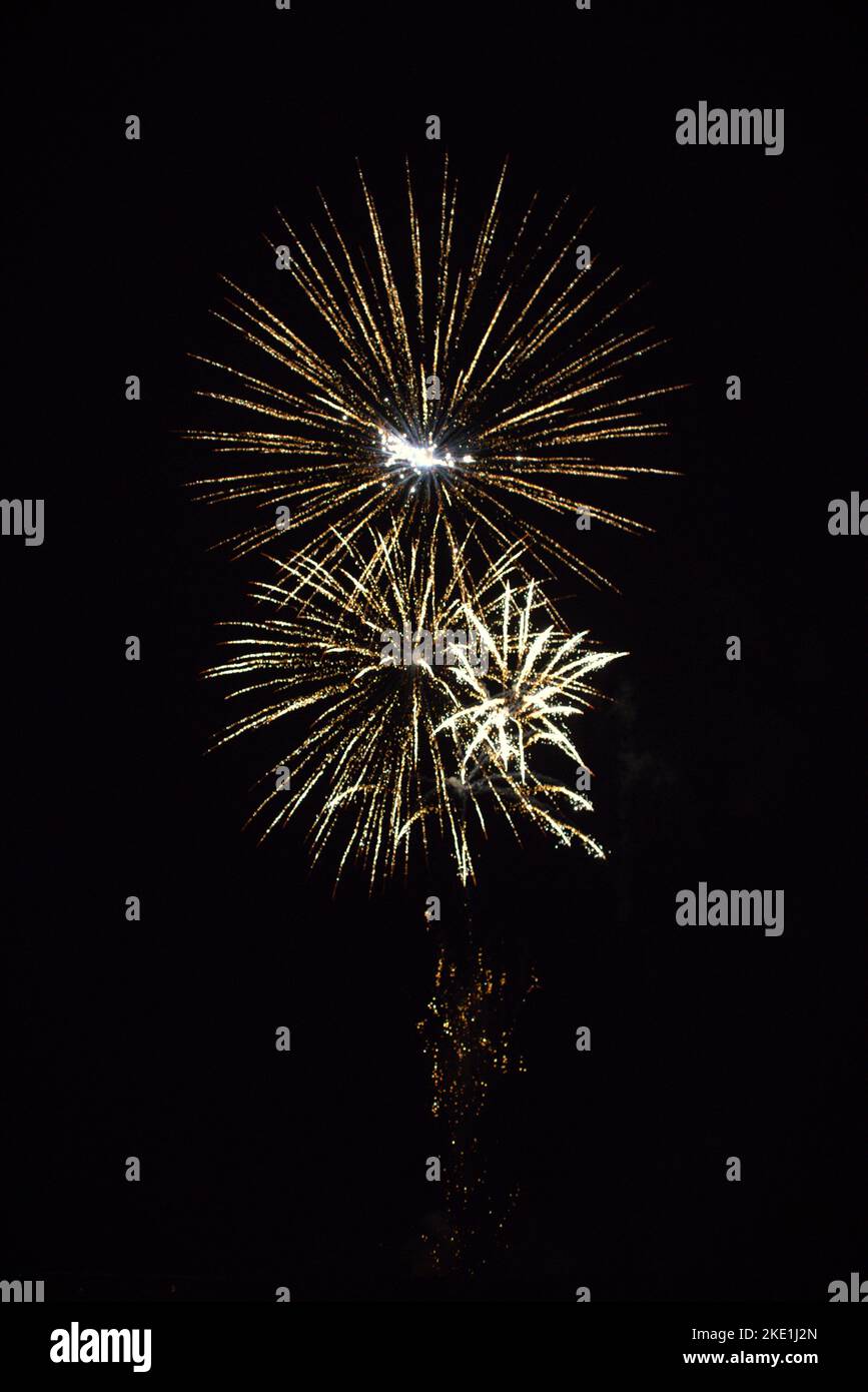 A vertical shot of fireworks at night Stock Photo - Alamy