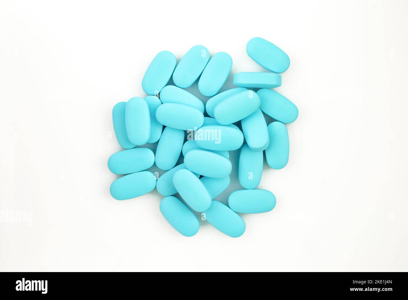 Pile of blue pills isolated on white background. Group of medications ...