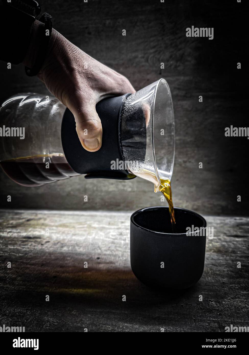 A person hand pouring coffee from a brewer Stock Photo - Alamy
