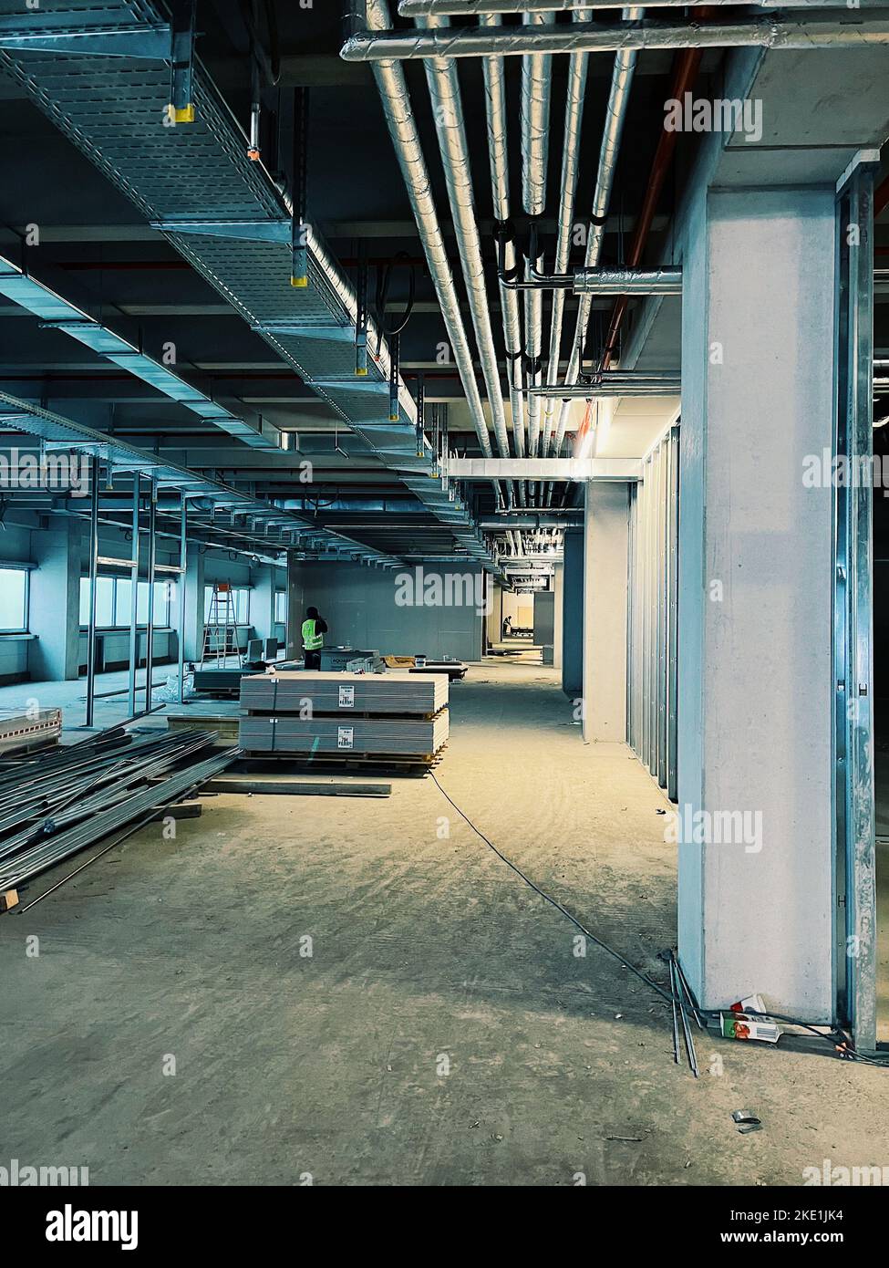 A vertical view of people working inside building under construction ...