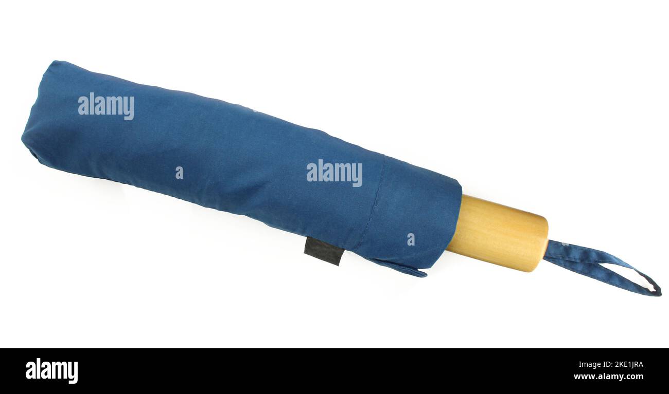 Small compact umbrella folded in blue casing isolated on white ...