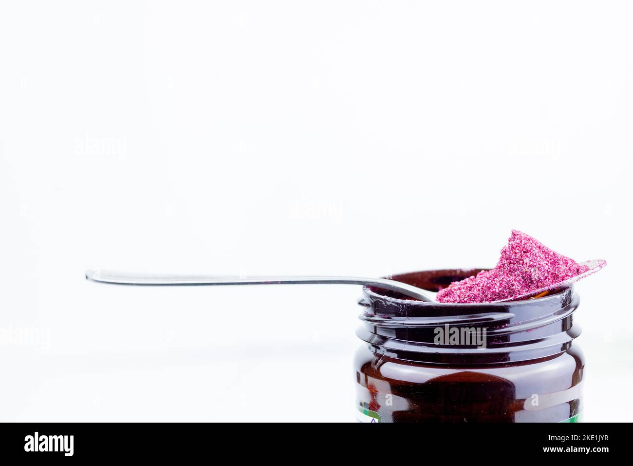 A jar of beetroot powder isolated on white Stock Photo - Alamy