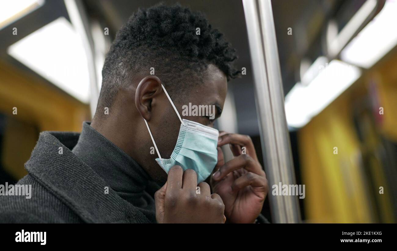 African man standing in subway metro wearing coronavirus mask ...
