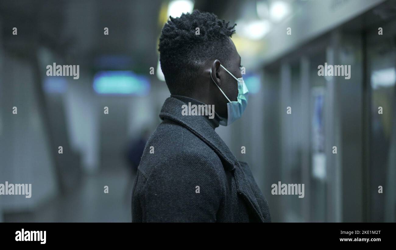 African man entering subway wagon wearing covid-19 face mask in ...