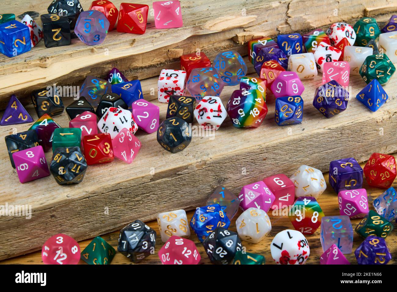 A closeup shot of a bunch of mixed polyhedral colorful gaming dice ...