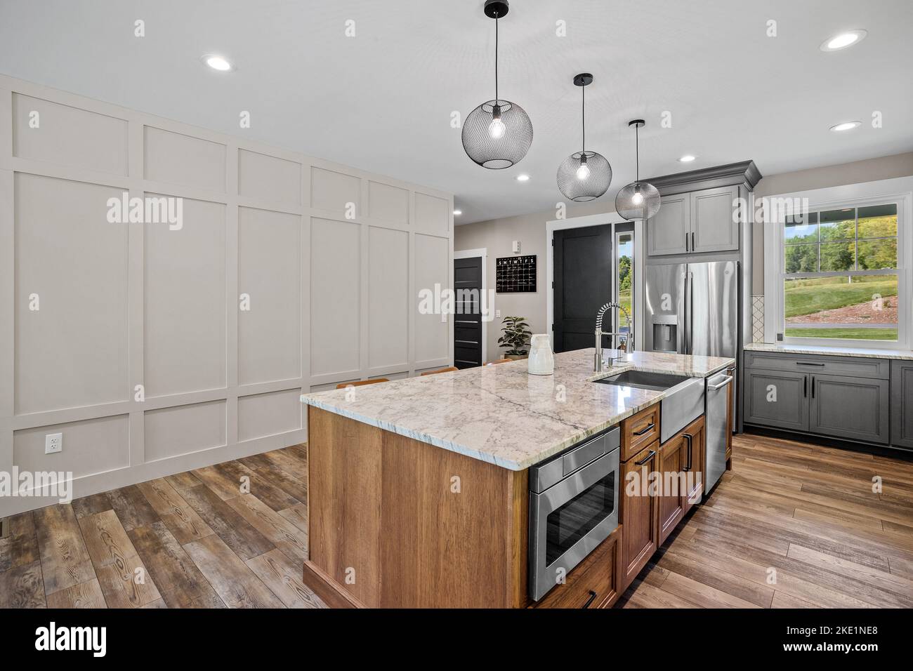 The interior design of a beautiful kitchen with a large island in a ...