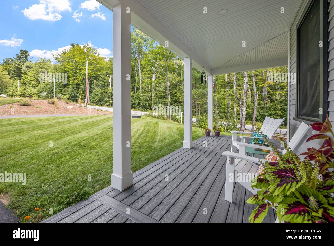 The beautiful gray porch of a modern custom new England colonial home ...
