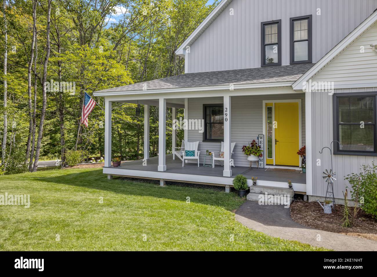 The beautiful gray porch of a modern custom new England colonial home ...