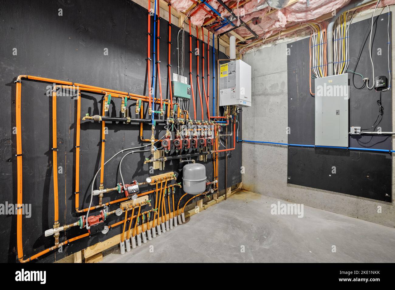The basement of a modern new England colonial home with water pipes and ...