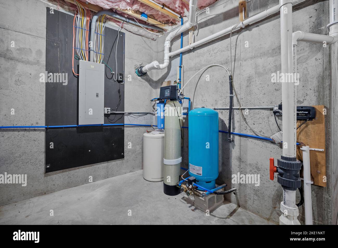 The basement of a modern new England colonial home with water pipes and ...