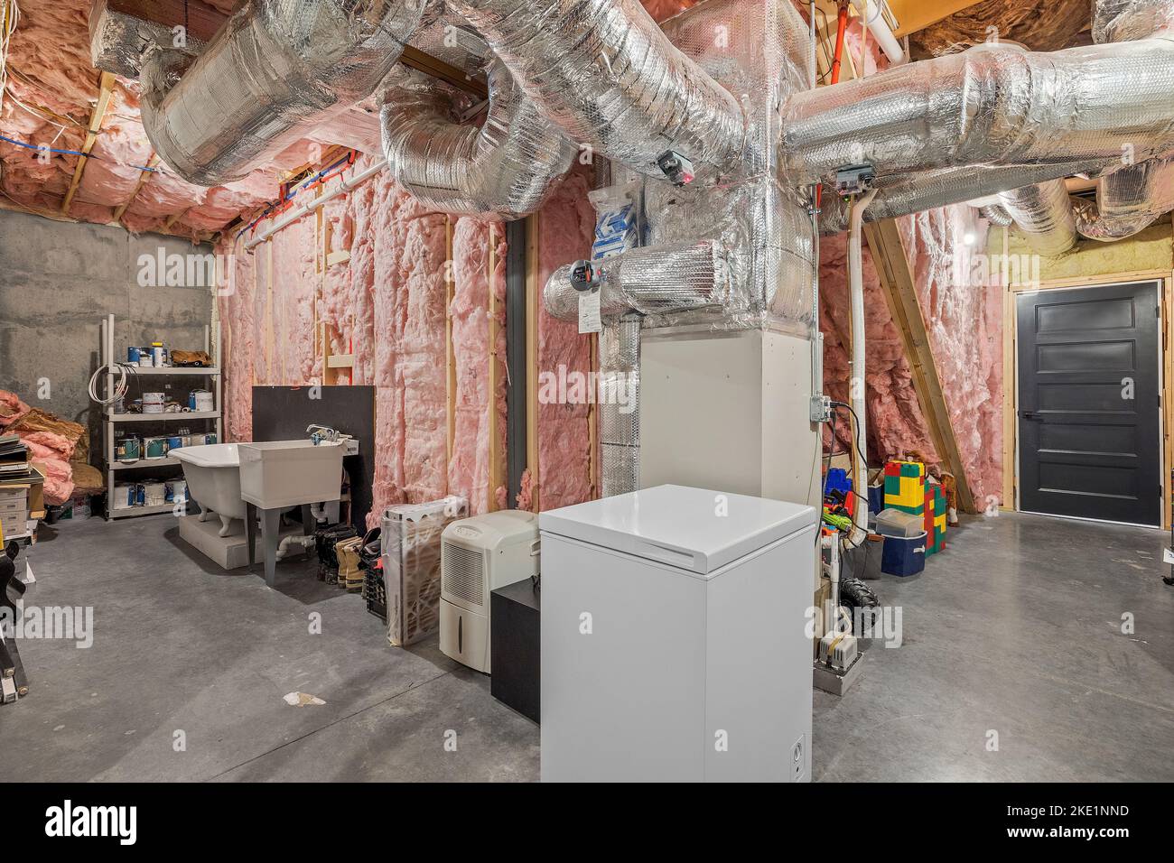 The basement of a modern new England colonial home with water pipes and ...