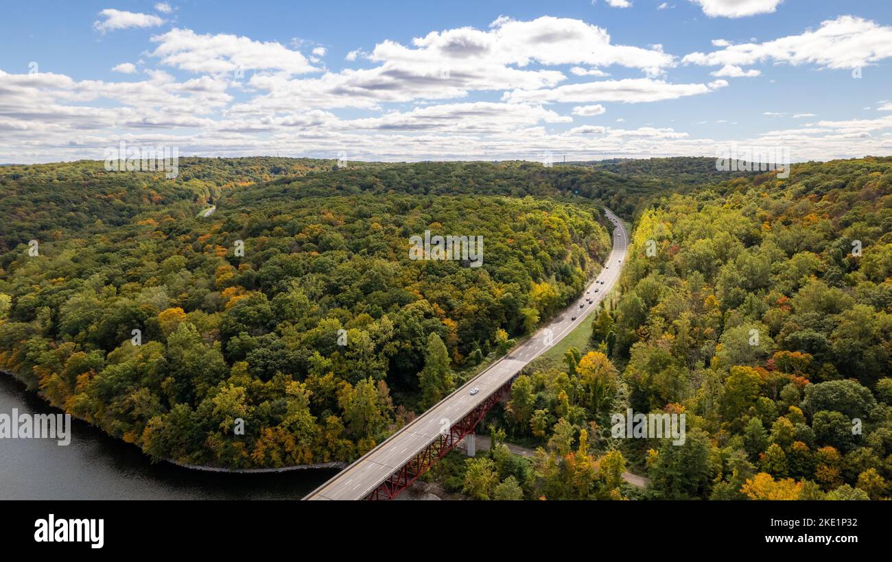 A drone shot of a bridge over the New Croton Reservoir on a sunny day ...