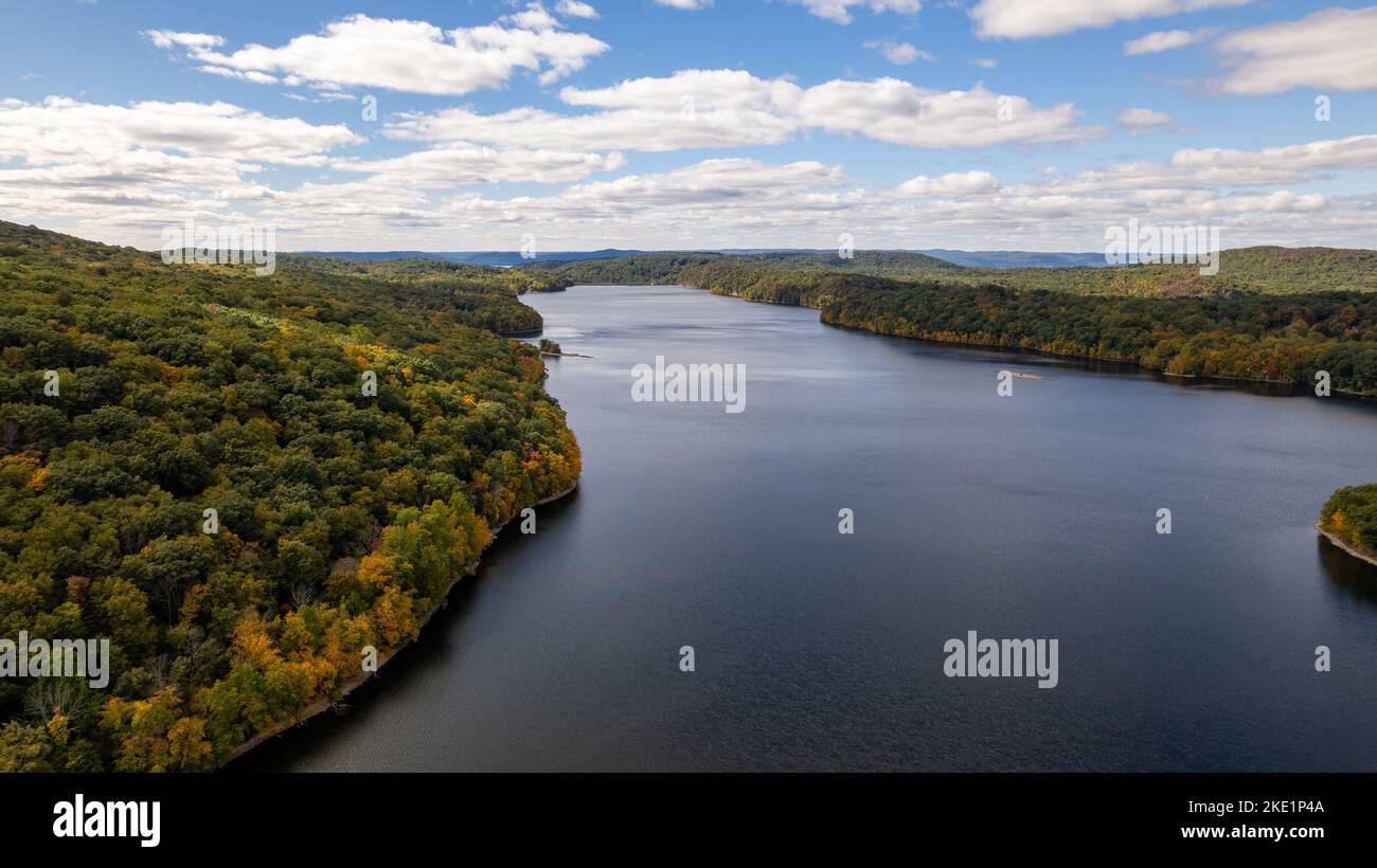 A drone shot of the New Croton Reservoir on a sunny day in autumn with ...