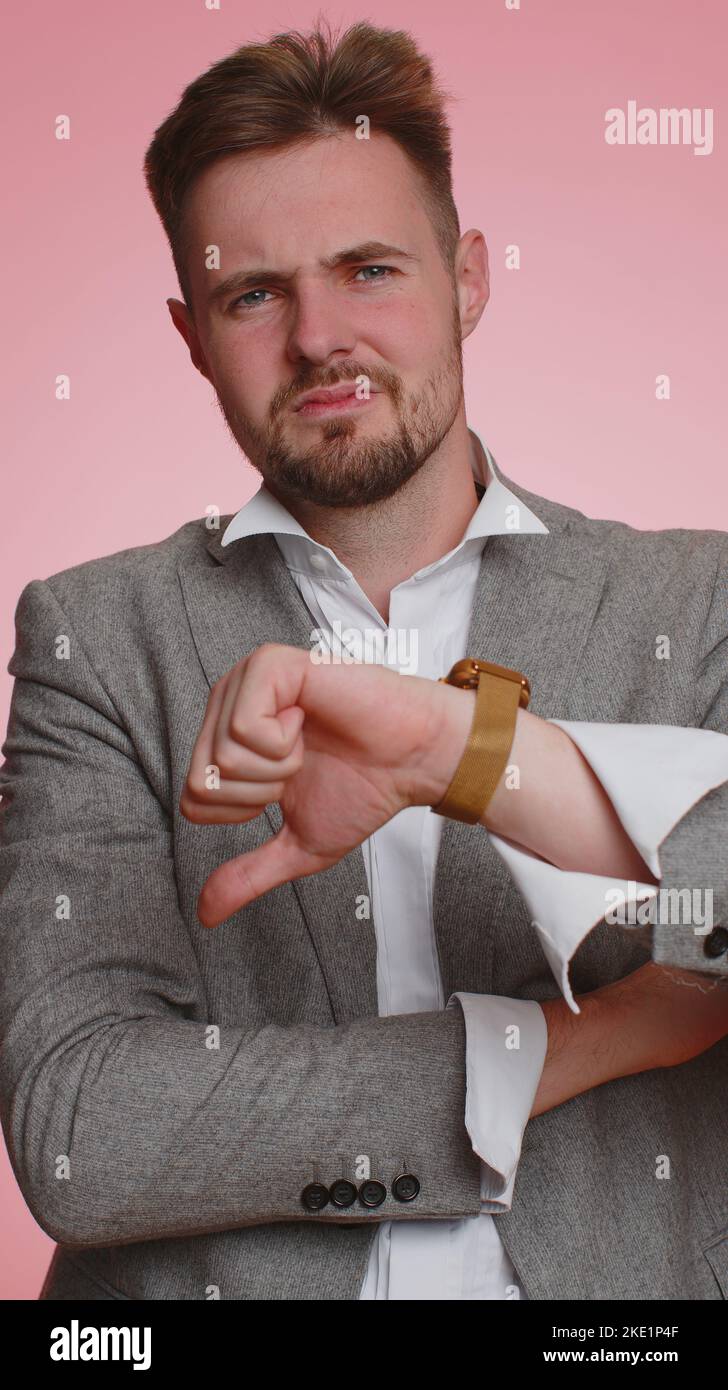 Dislike. Upset unhappy handsome business man showing thumbs down sign gesture, expressing ...