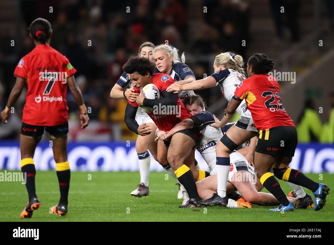 Papua New Guinea's Elise Albert is tackled by England's Hollie Dodd ...