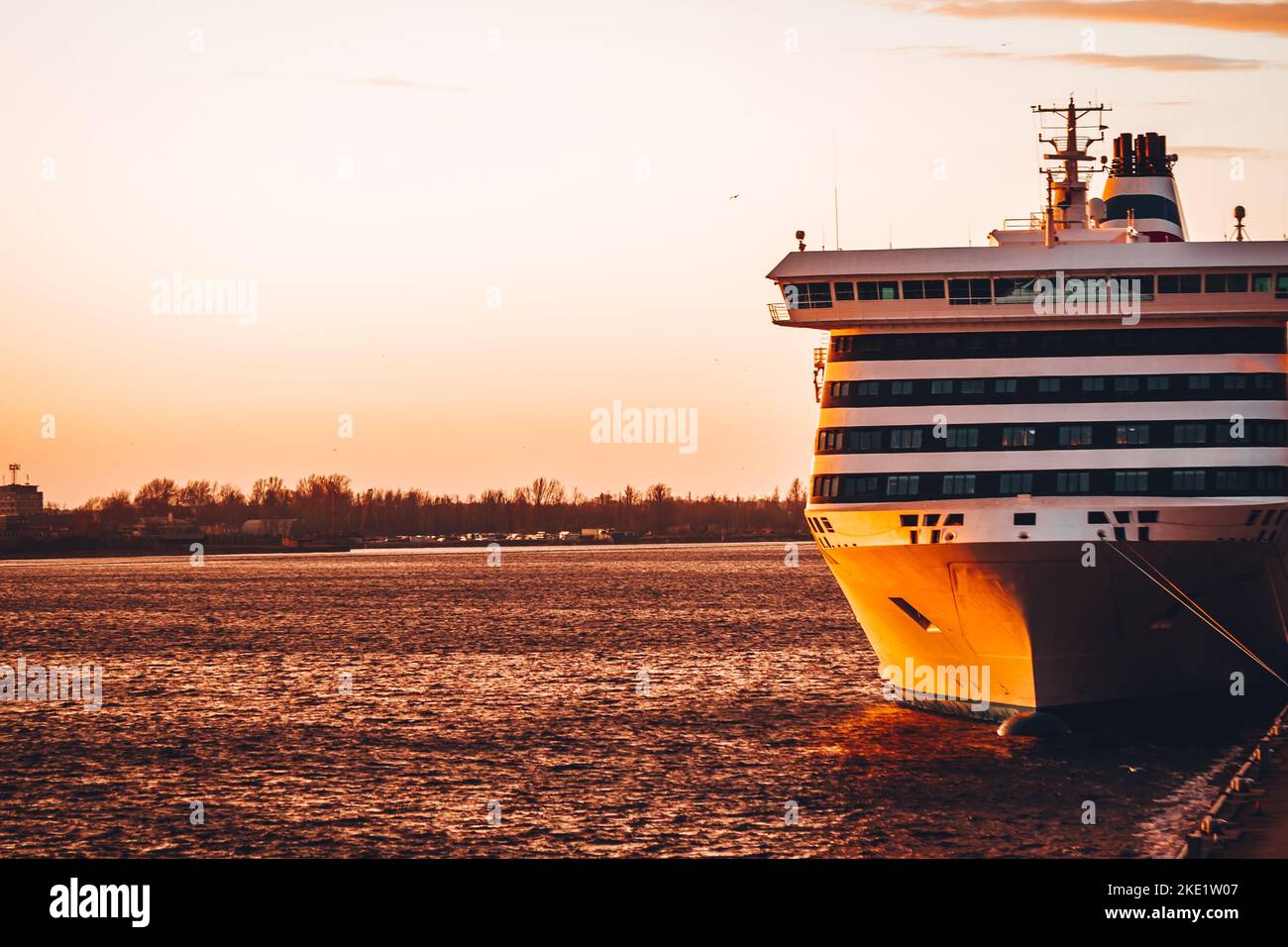 A closeup shot of the cruise ship near the pier in a small town during ...