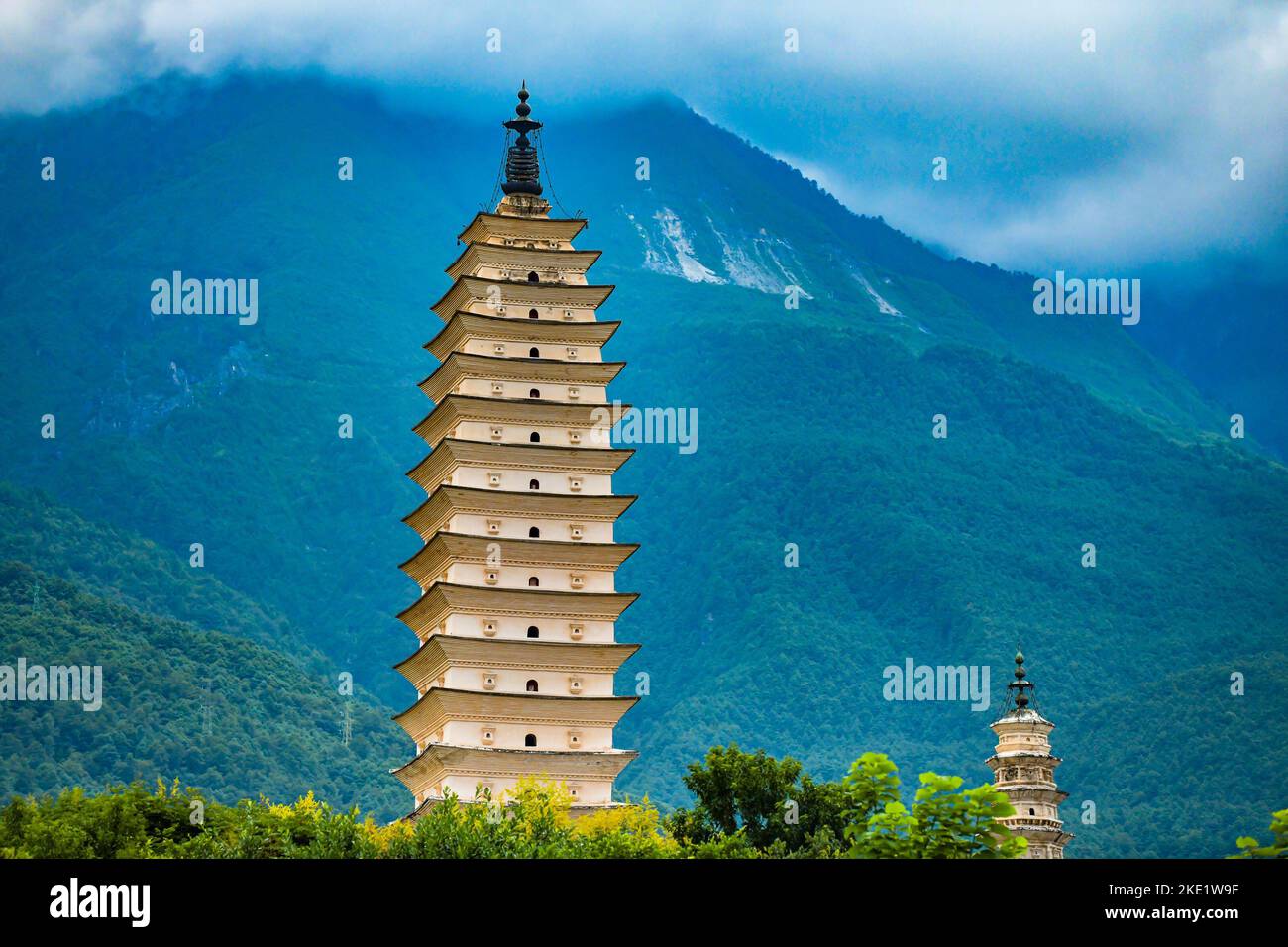 The Three Pagodas of Chongsheng Temple in China with mountains in the ...