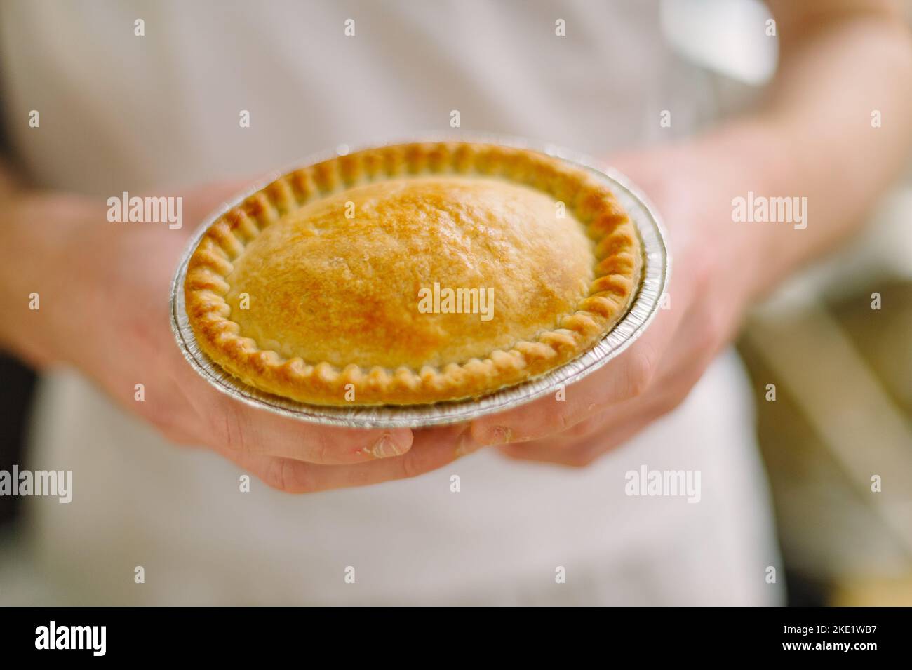 Pie's and pasties for sale in a bakery, hands holding a pie Stock Photo ...