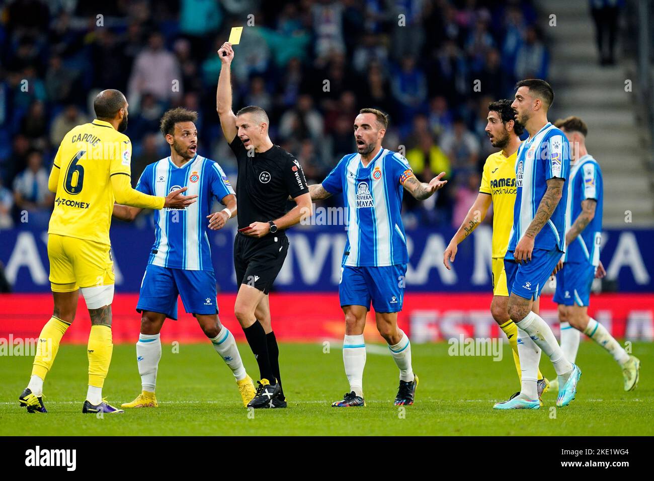 The referee shows yellow card to Etienne Capoue of Villarreal CF during ...