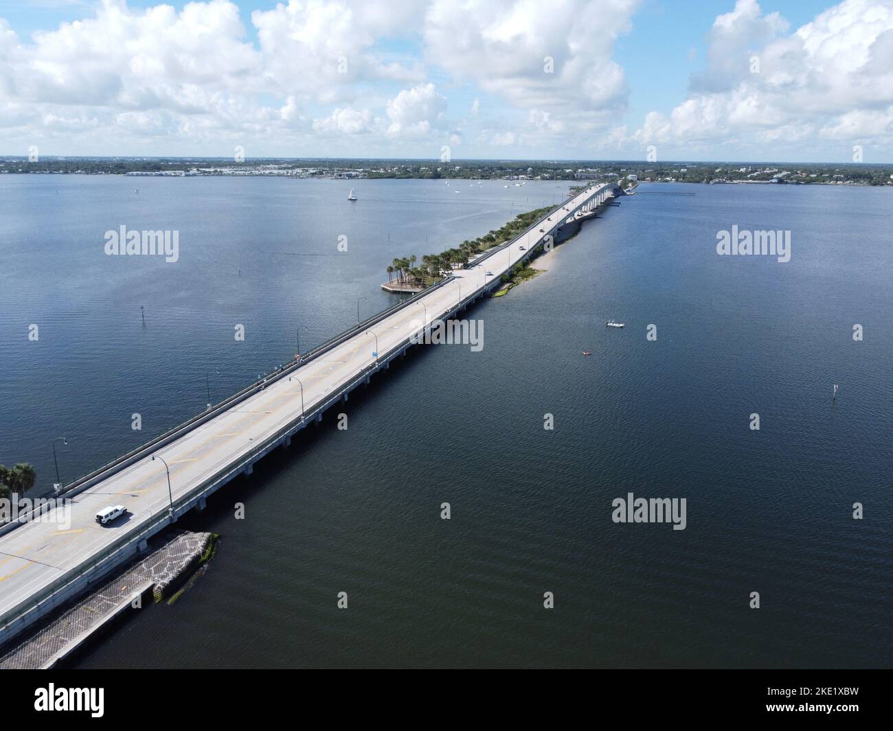 An aerial view of Jensen Beach Causeway bridge surrounded by a blue ...