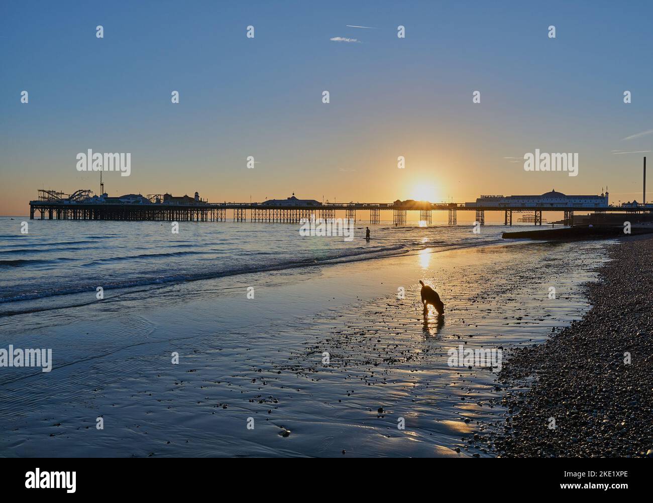 A beautiful scenery of vibrant sunset on Brighton Beach over the ocean ...