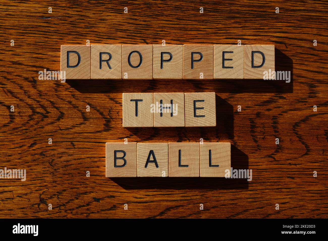 Dropped The Ball, words in wooden alphabet letters on woodgrain ...