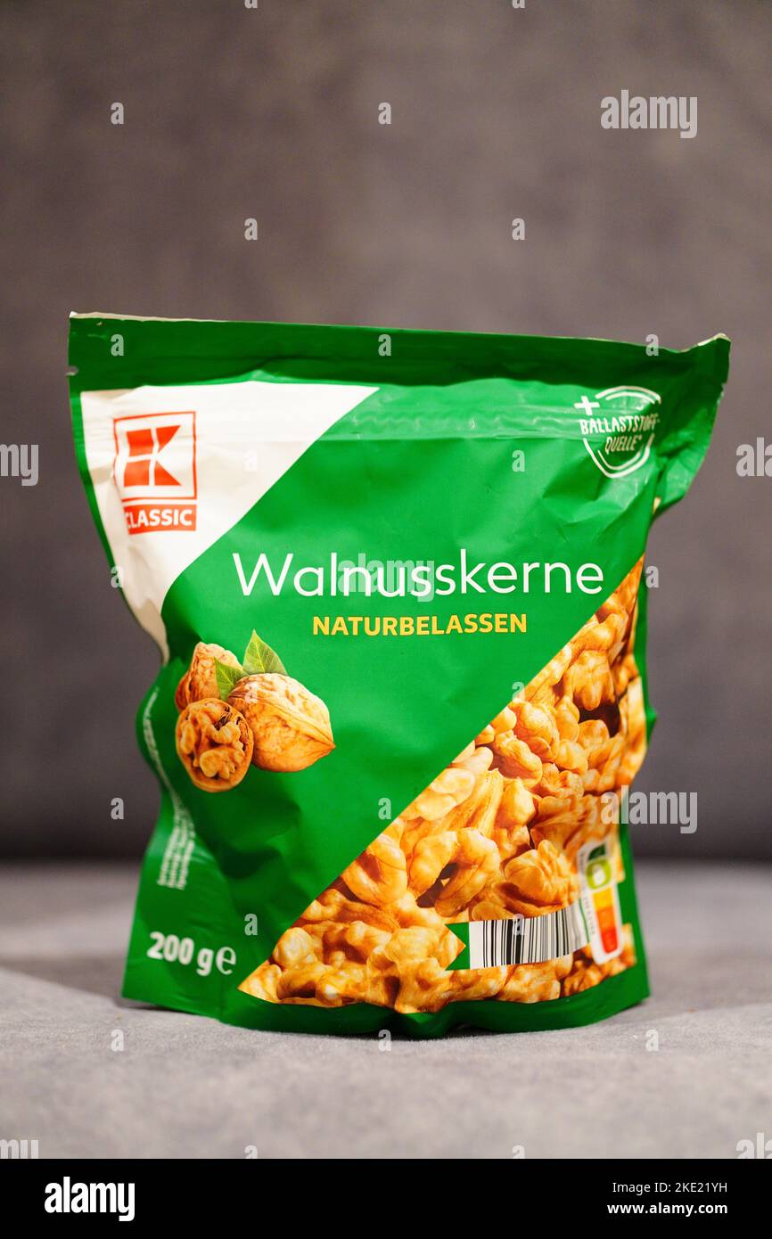 A vertical closeup of German Kaufland brand walnuts without shell in a ...