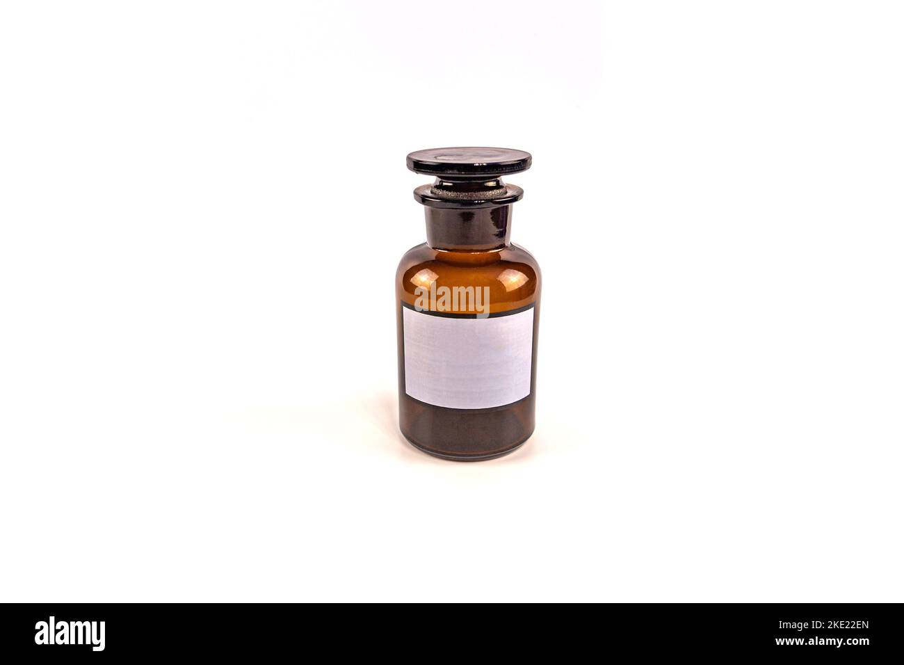 Brown medical jar with a glass stopper on a white background with a ...