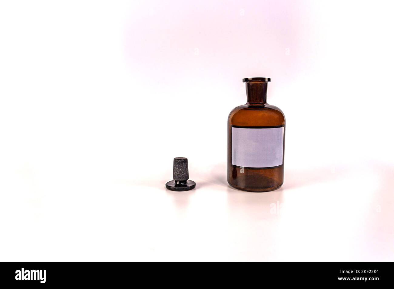 Brown medical jar with a glass stopper on a white background with a ...