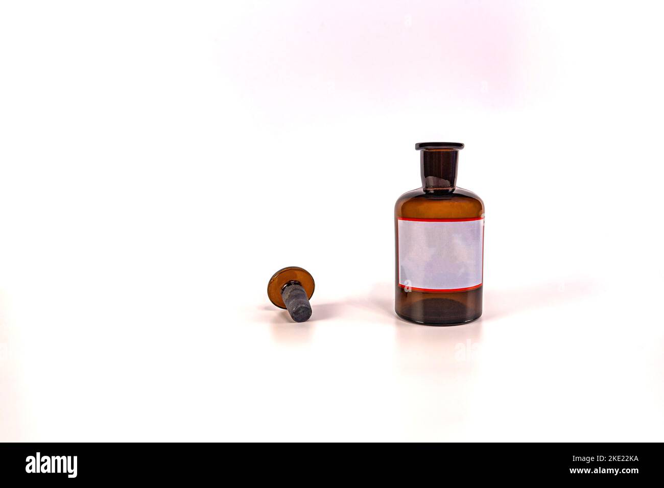 Brown medical jar with a glass stopper on a white background with a ...