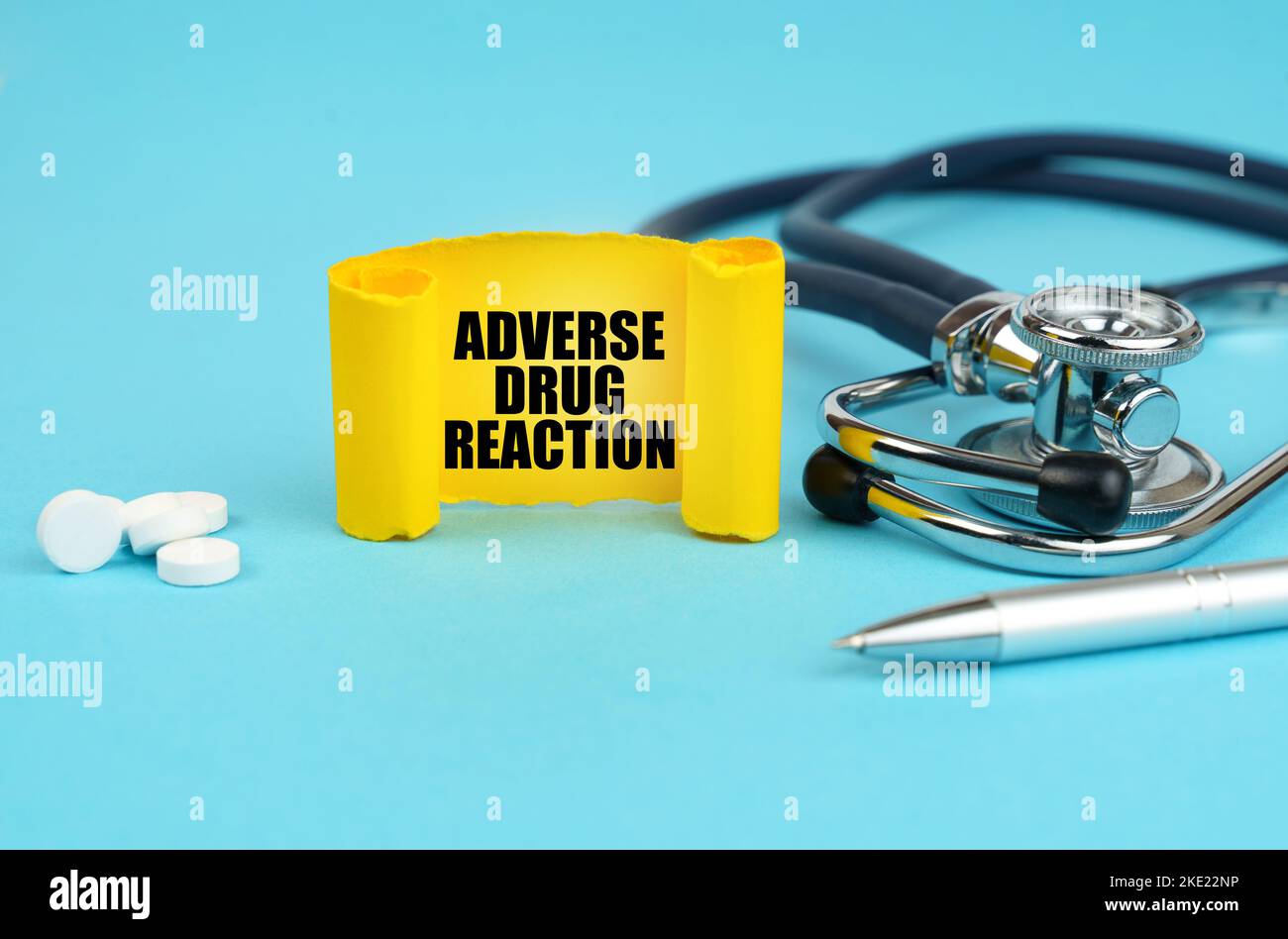 Medical concept. On a blue surface, a stethoscope, pills, a pen and a ...