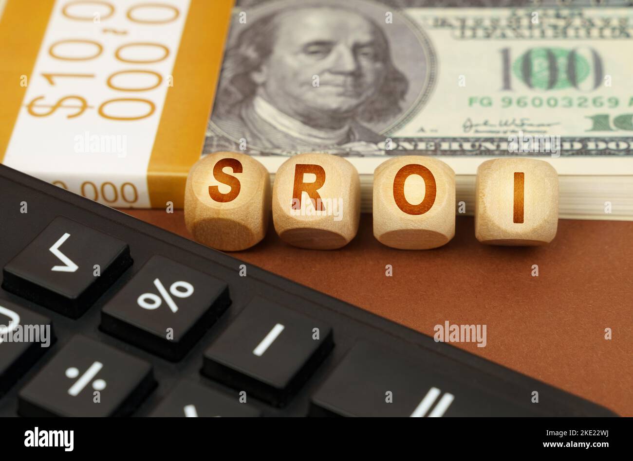 Business concept. On a brown surface are dollars, a calculator and ...