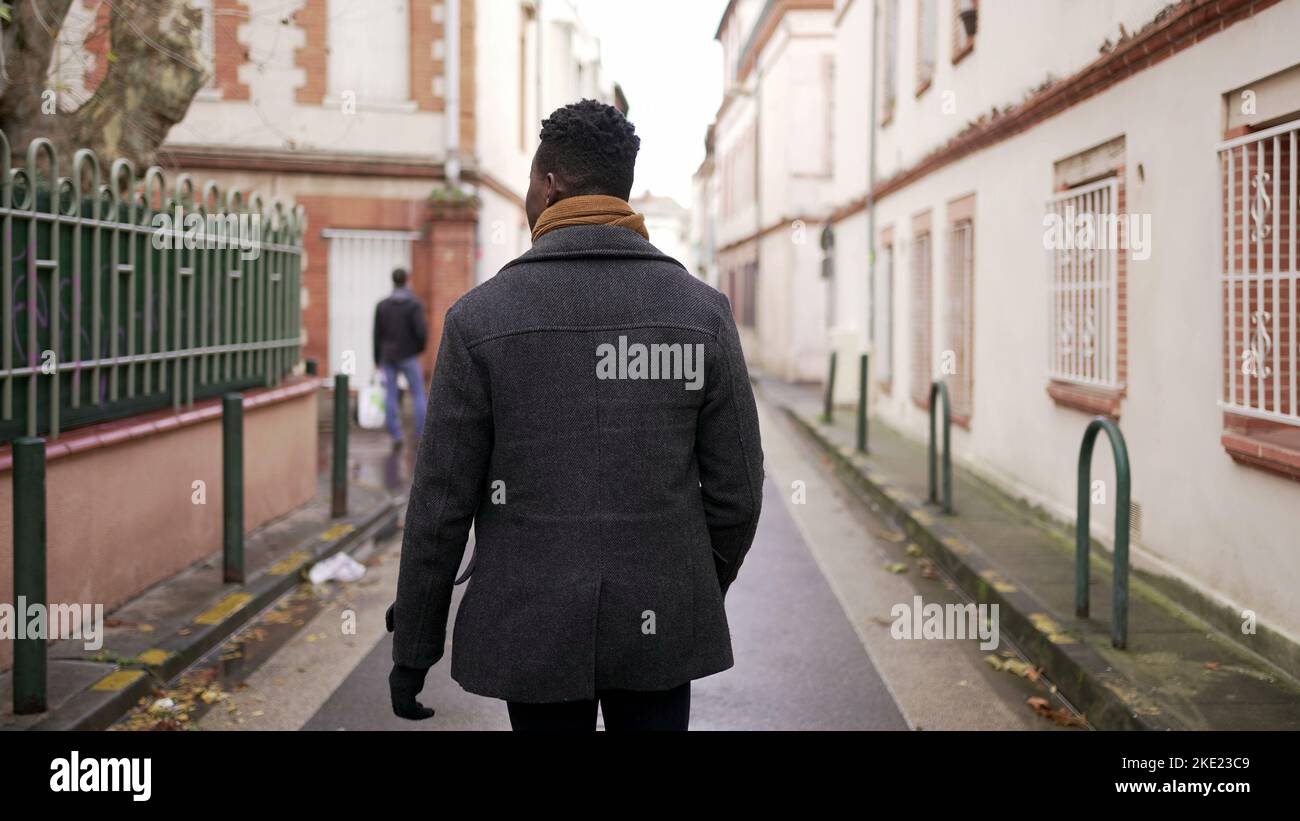 Back of black walking outside in city. African person perspective in ...