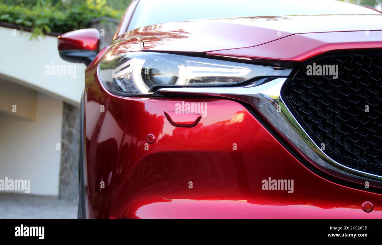 Modern red car on parking at private area Stock Photo - Alamy