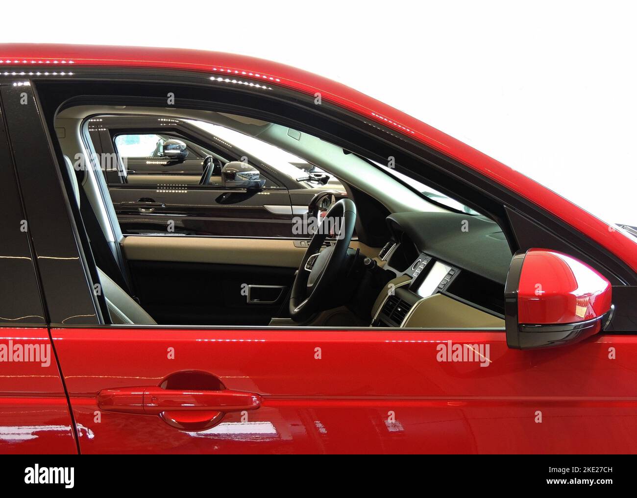 Side view through rolled window of vehicles interiors in dealership ...