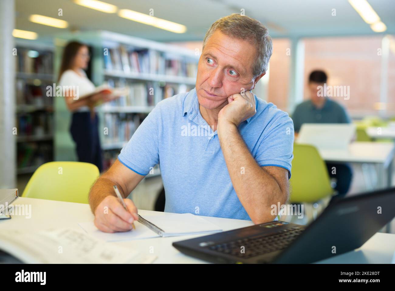 Elderly adult in public library hi-res stock photography and images - Alamy