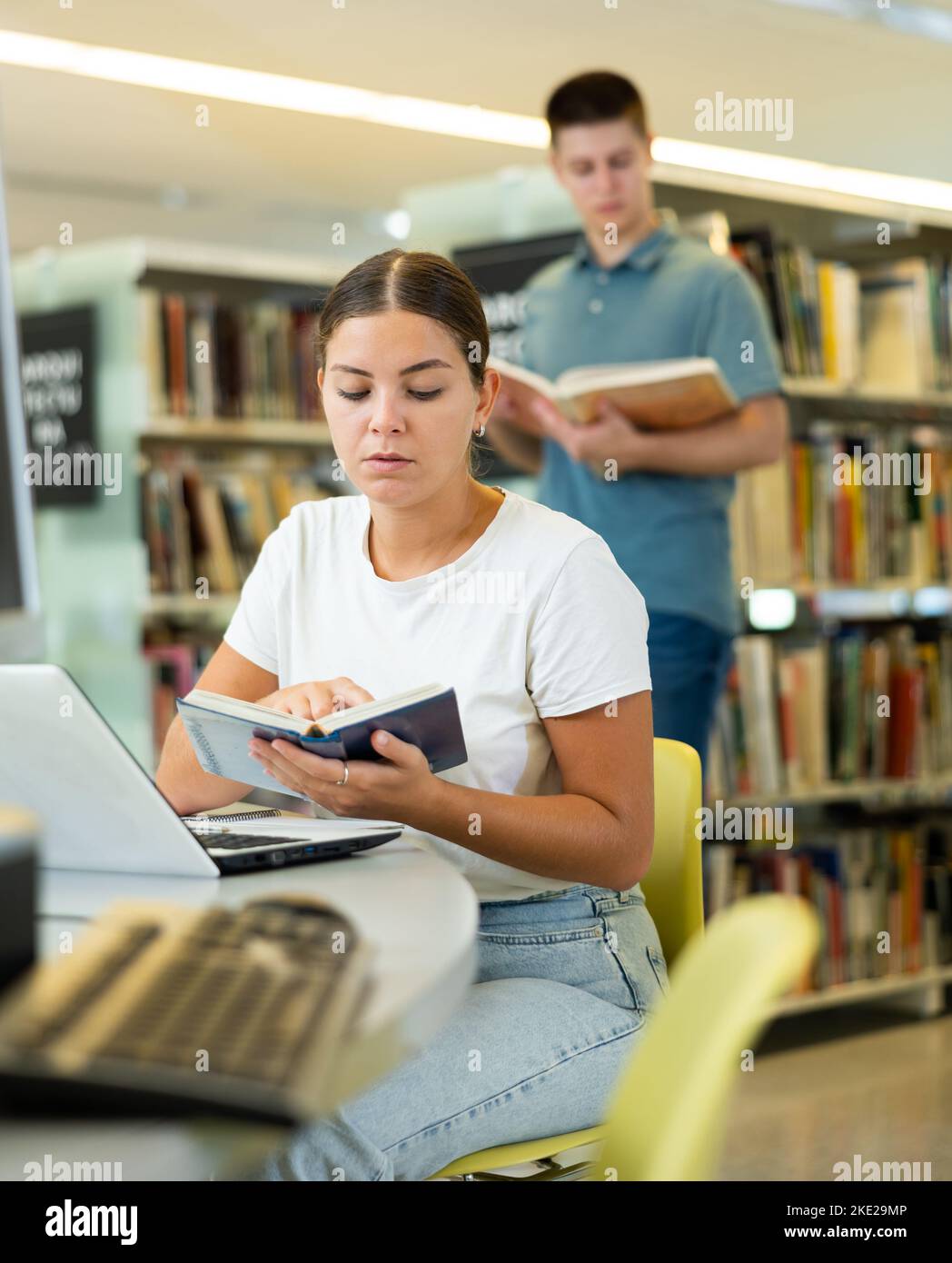 Positive young lady working remotely using a computer in a quiet ...