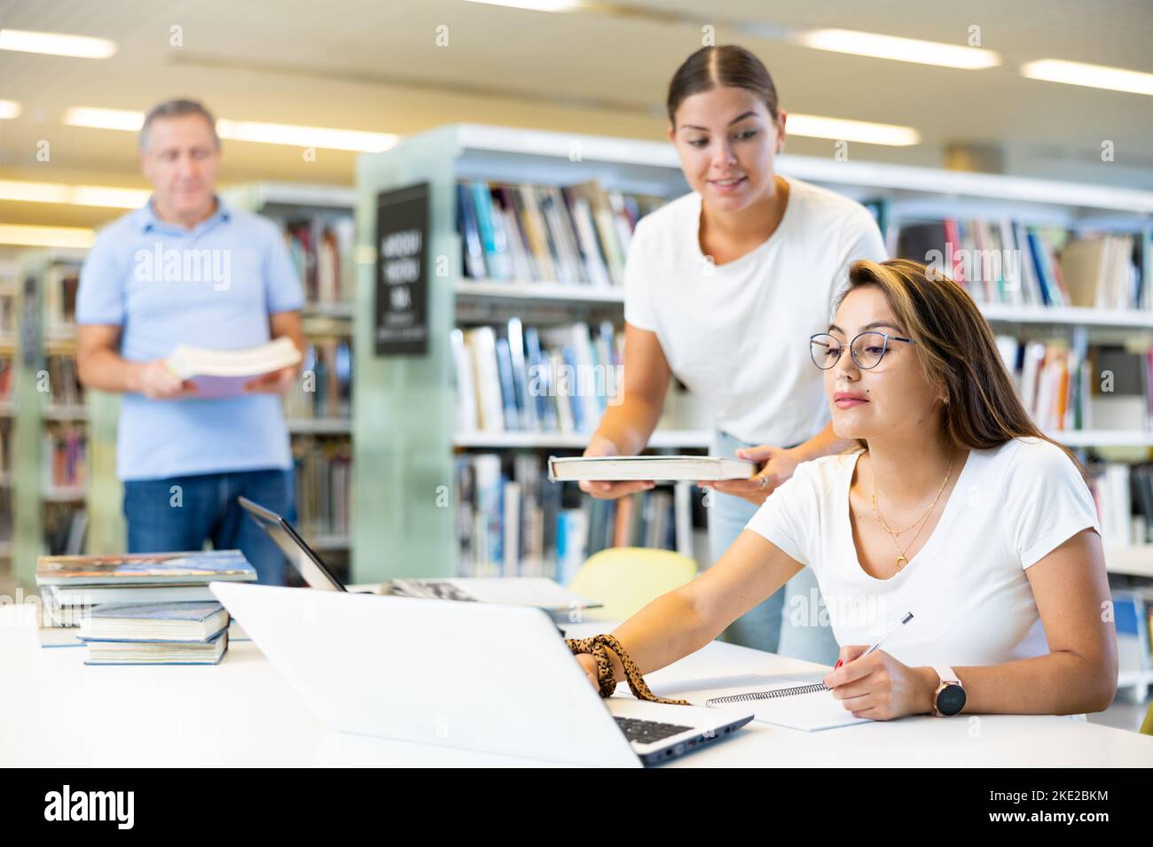 Student girls work together on project in the college library Stock ...