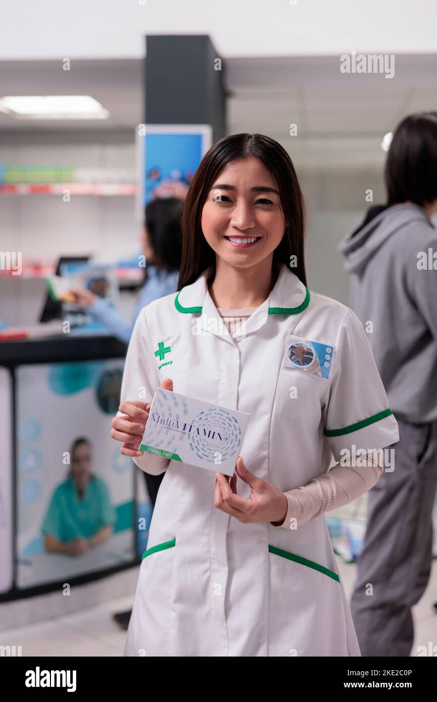 Asian pharmacist showing medicaments hi-res stock photography and ...