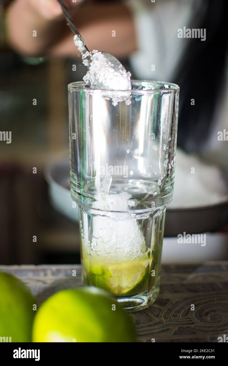 Bartender making refreshing coctail on a bar background. Dark moody ...