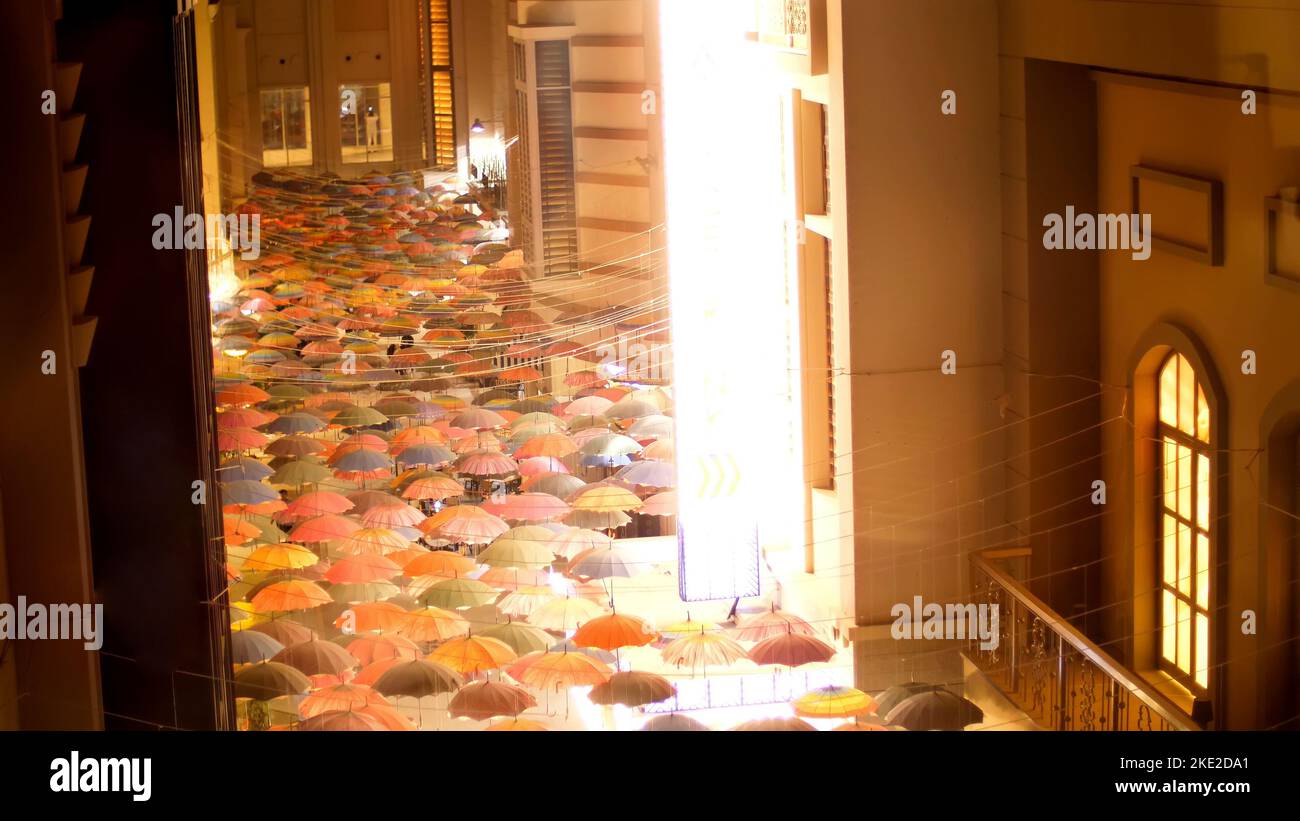 Dubai Mall, in reflection of storefront, dozens of open multi-colored ...