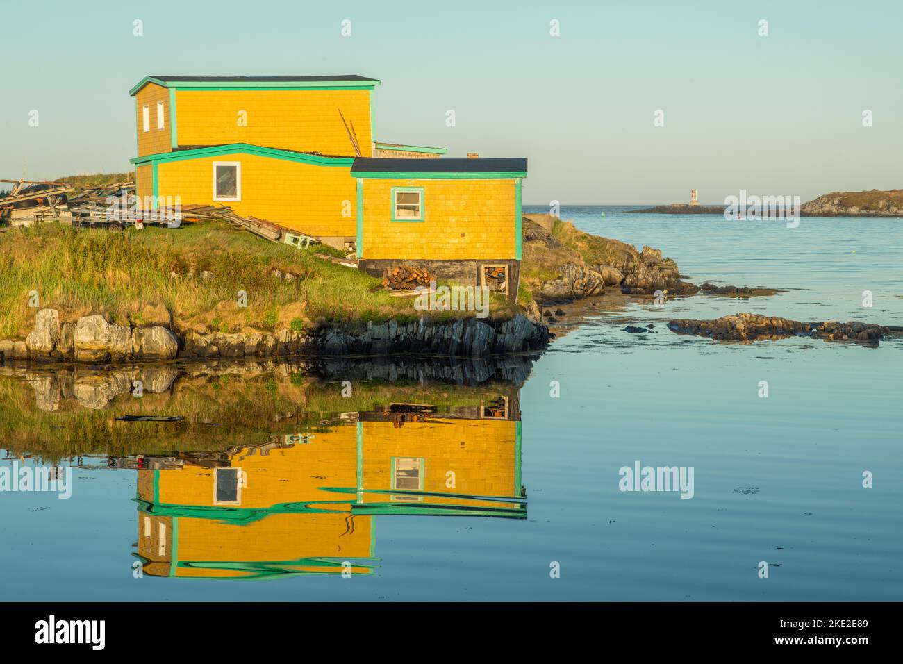 Yellow house on a point with reflection, Margaree, Newfoundland and ...