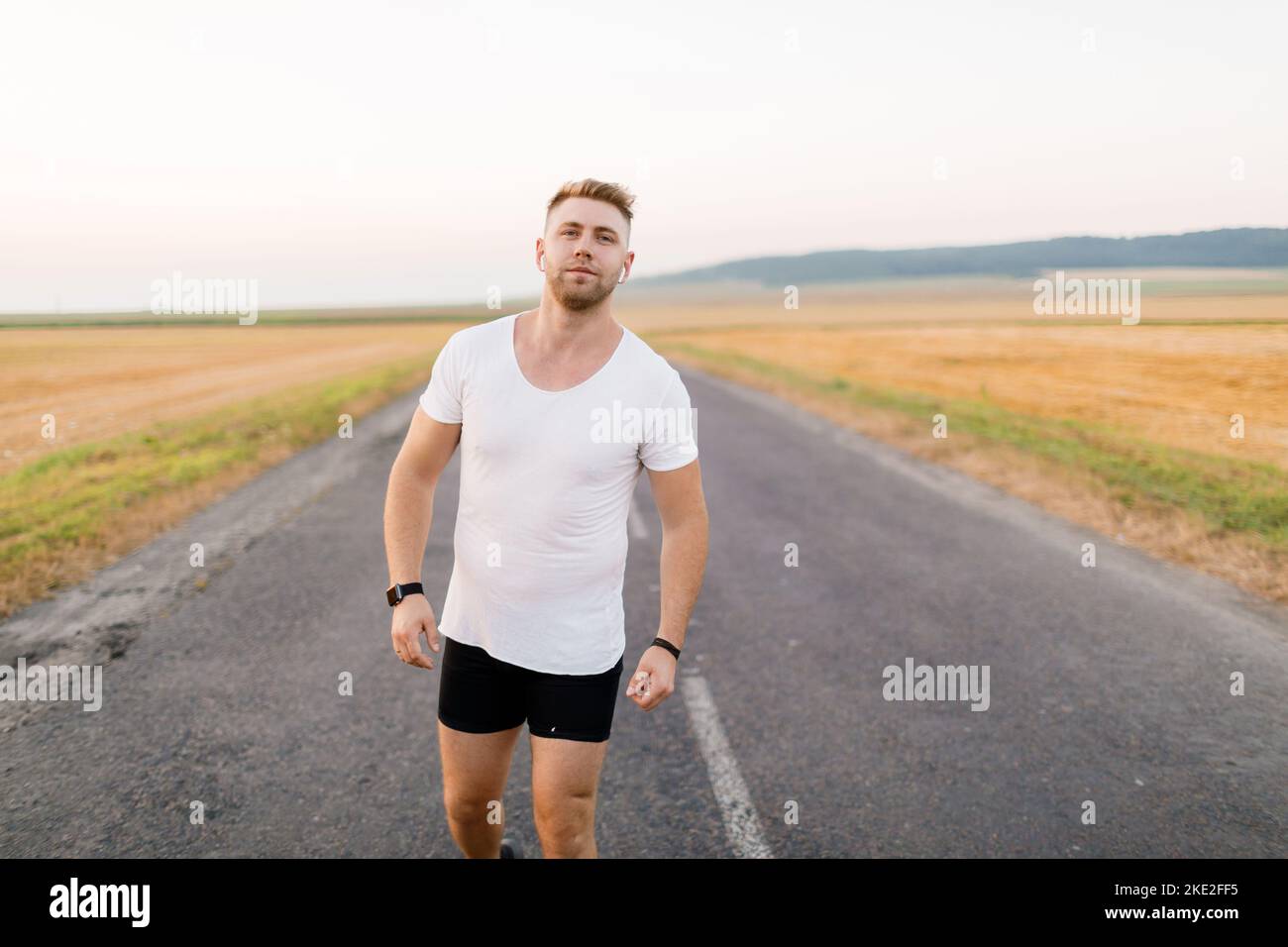 Sporty man running outdoors Stock Photo - Alamy