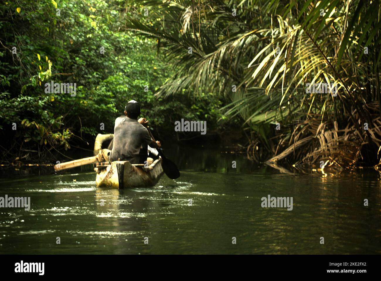 National park rangers travelling by boat on Cigenter river through the ...