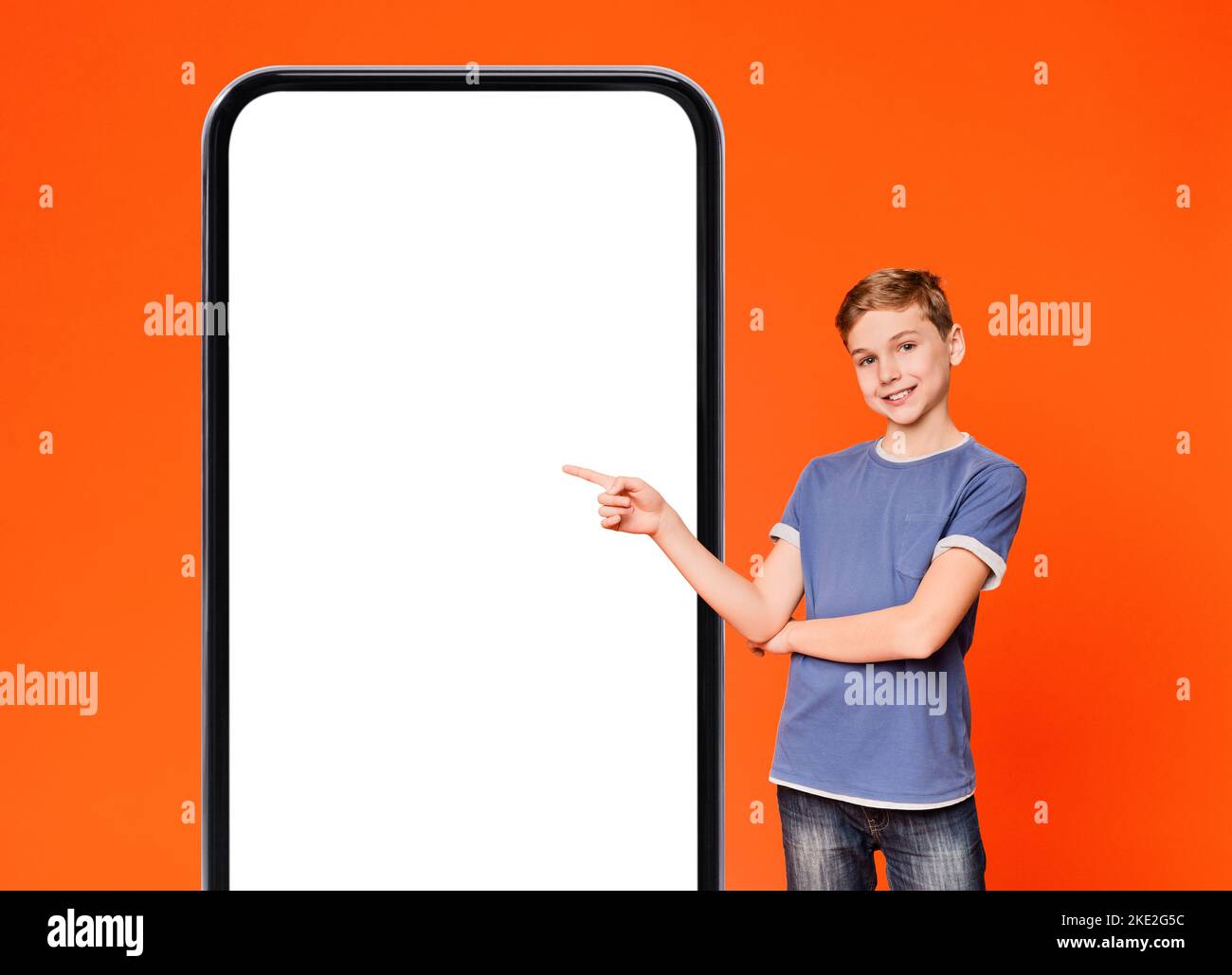 Online Offer. Smiling Preteen Boy Pointing At Blank Smartphone With ...