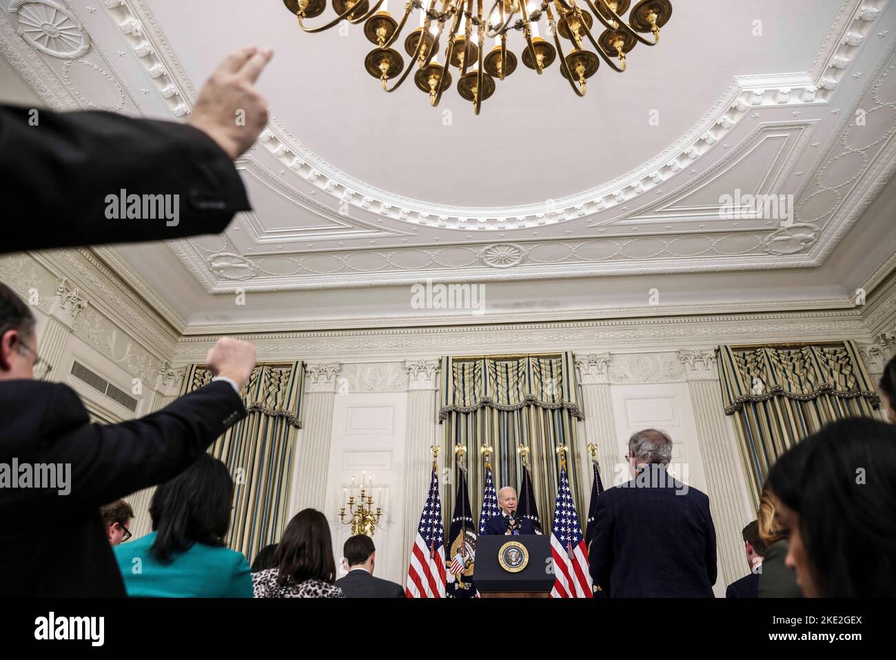 Members of the media raise their hands for questions as President Joe ...