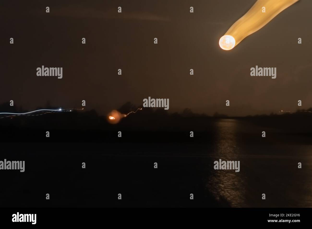 Lunar eclipse moon trail golden light light against dark sky and ...