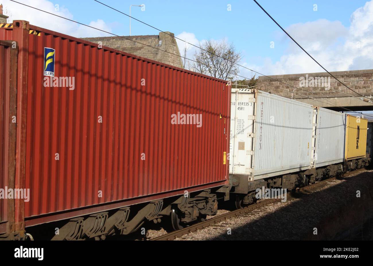 Side view of containers on a container train passing through Carnforth ...
