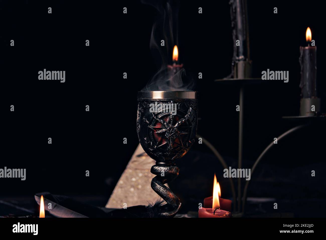 Witchcraft composition with candles, magic book and pentagram symbol ...